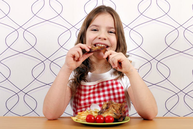 Girl eating chicken wings stock image. Image of child - 61673675