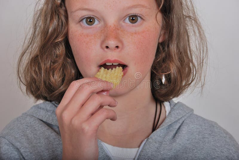 Girl eating chip stock photo. Image of happiness, chip - 34835778
