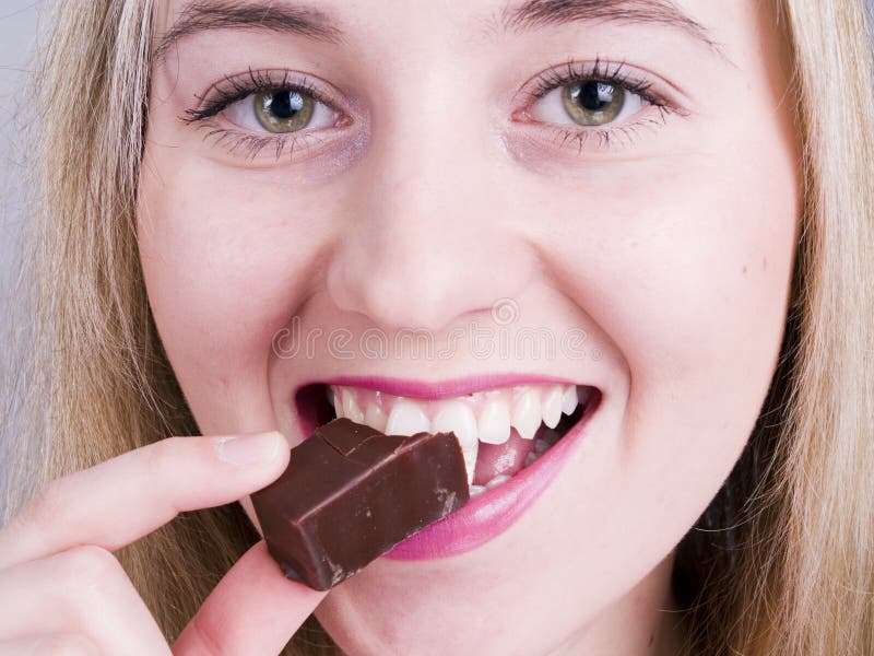 Girl eating chocolate stock photo. Image of smiling, candy - 3620220