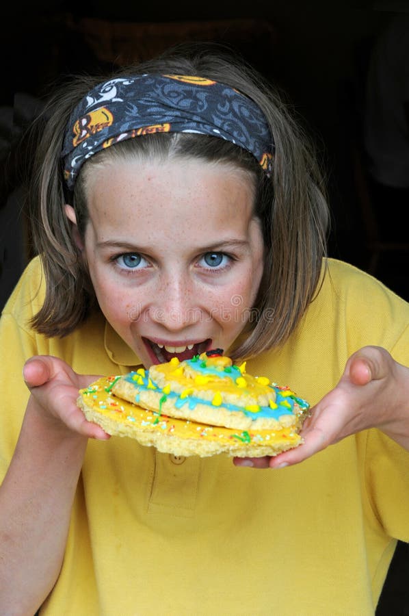 Girl eating cookie stock photo. Image of cheeky, icing - 5224898