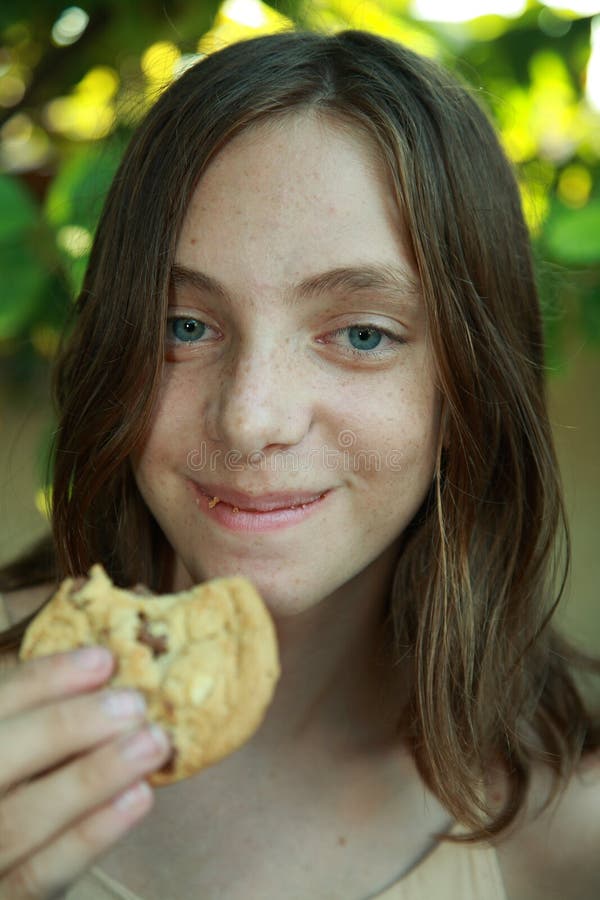 Girl eating cookies stock image. Image of girls, chew - 5710895
