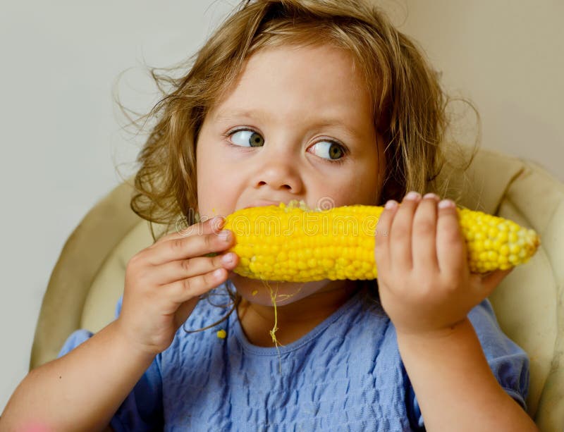 Girl eating corn stock photo. Image of food, chair, cuisine - 42450426