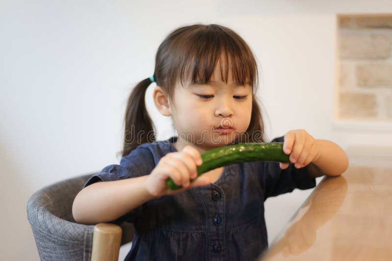 Girl eating cucumber stock photo. Image of nose, eating - 344466442