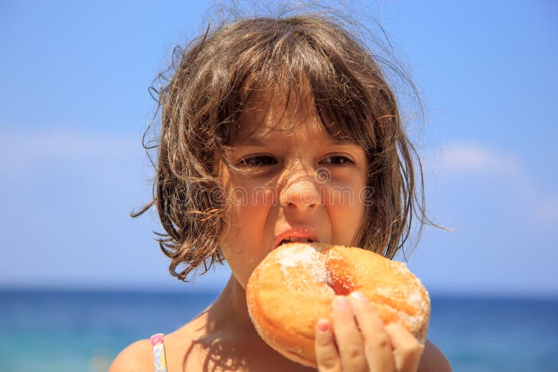 Girl eating donut stock image. Image of child, happy - 43800429