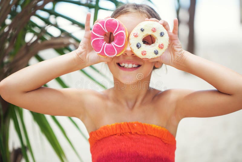 Girl eating donuts stock image. Image of dough, delicious - 54495457