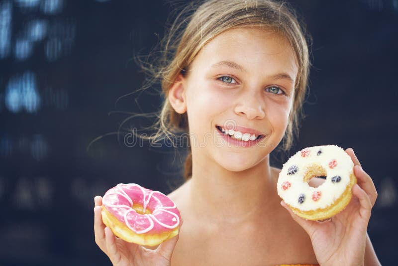 Girl eating donuts stock photo. Image of cheerful, preteen - 54495728