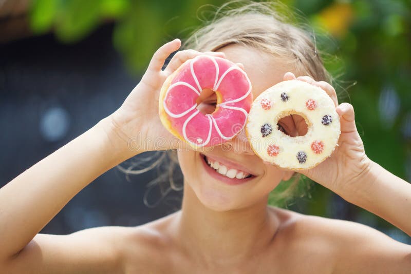 Girl eating donuts stock image. Image of breakfast, bakery - 54496007