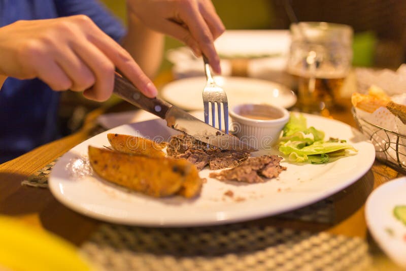 Girl Eating Meat with Salad in a Restaurant Stock Image - Image of ...