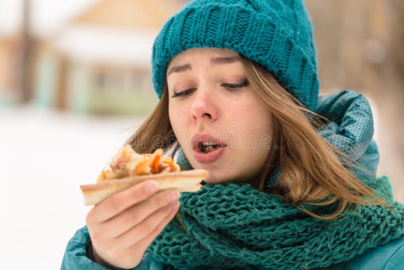 Girl Eating Pizza in the Cold Winter Stock Photo - Image of female ...