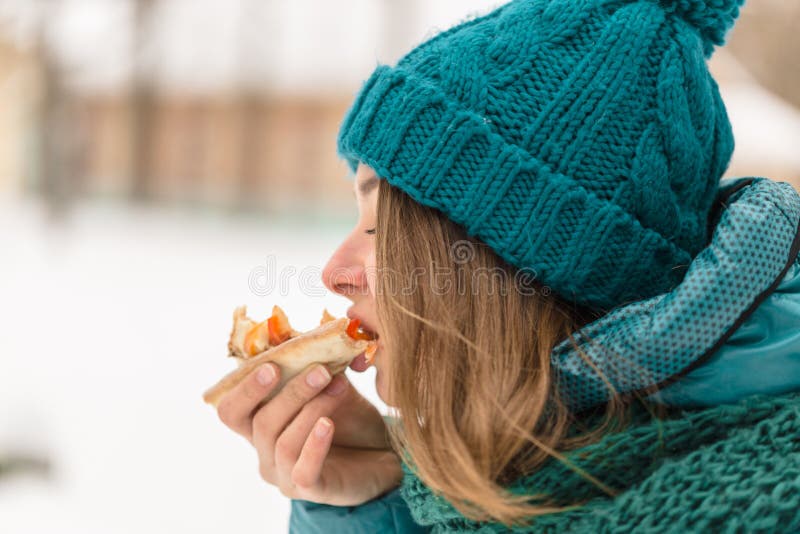 Girl Eating Pizza in the Cold Winter Stock Image - Image of street ...