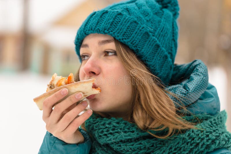 Girl Eating Pizza in the Cold Winter Stock Image - Image of woman ...