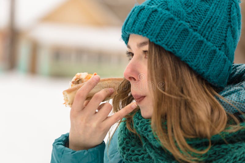 Girl Eating Pizza in the Cold Winter Stock Photo - Image of eating ...