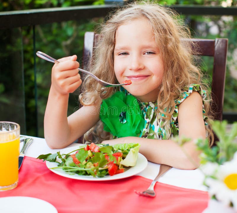 Girl Eating Salad at a Cafe Stock Image - Image of cheerful, children ...