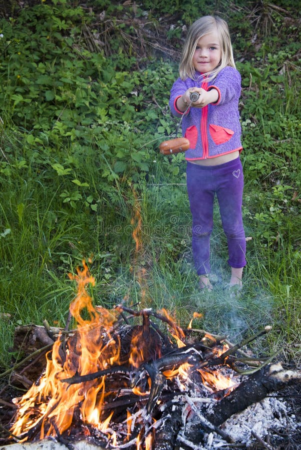 Girl Eating Sausage Cooked on Camp Fire Stock Photo - Image of roasting ...