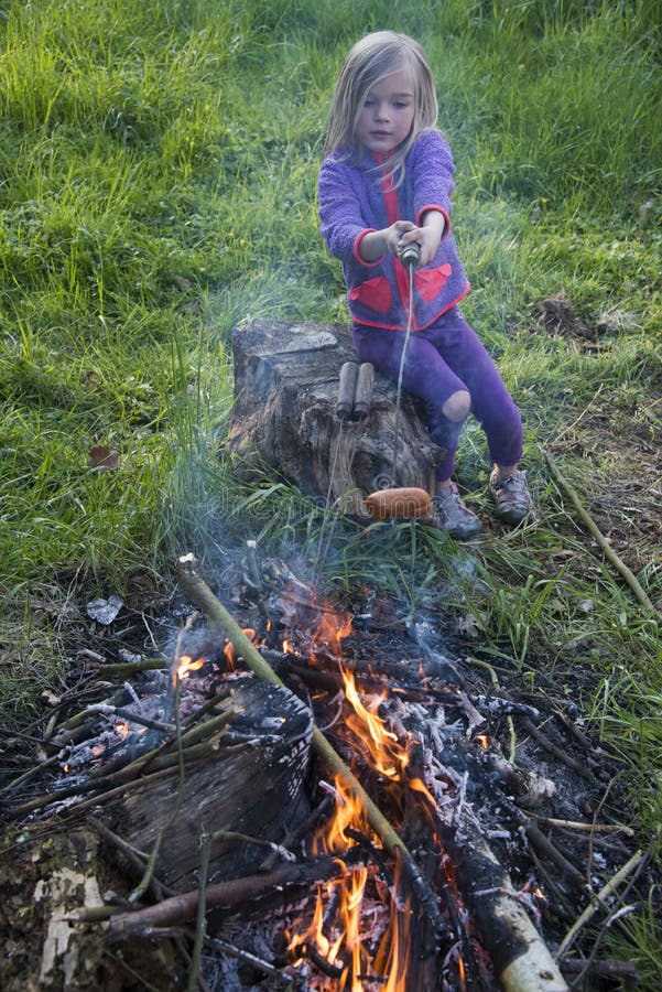 Girl Eating Sausage Cooked on Camp Fire Stock Image - Image of grilling ...