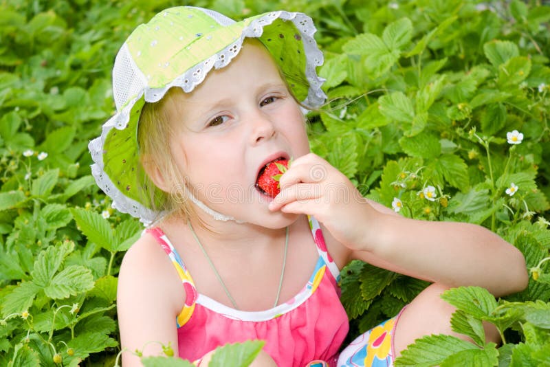 Girl eating strawberries stock photo. Image of child - 15998662