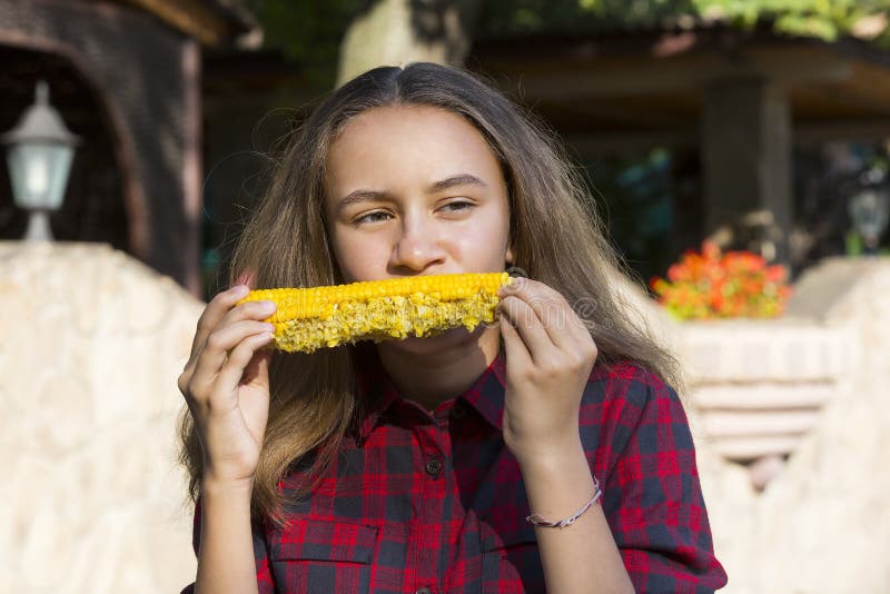 Girl eating sweet corn stock image. Image of female, child - 76379083