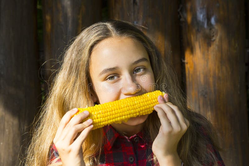 Girl eating sweet corn stock photo. Image of nature, nibble - 76379118