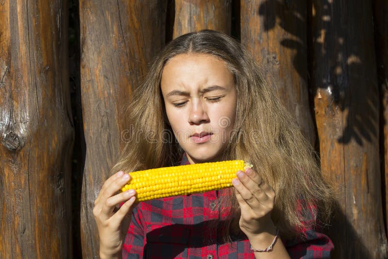 Girl eating sweet corn stock photo. Image of outdoor - 76379182