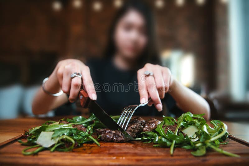 A Girl Eats a Steak Close-up in a Restaurant Stock Photo - Image of ...