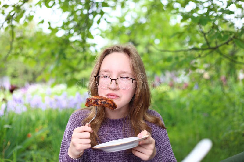 The Girl Eats a Steak in Nature. Picnic Stock Photo - Image of food ...