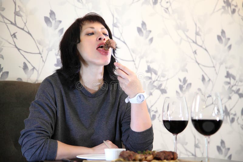 Girl Eats Steak with Wine. Girl Passionately Eats Steak Stock Photo ...