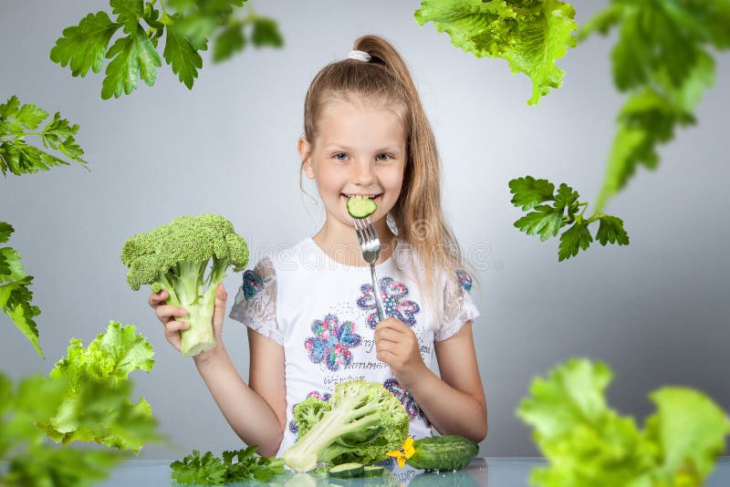 Girl eats vegetables stock image. Image of kids, green - 50598737