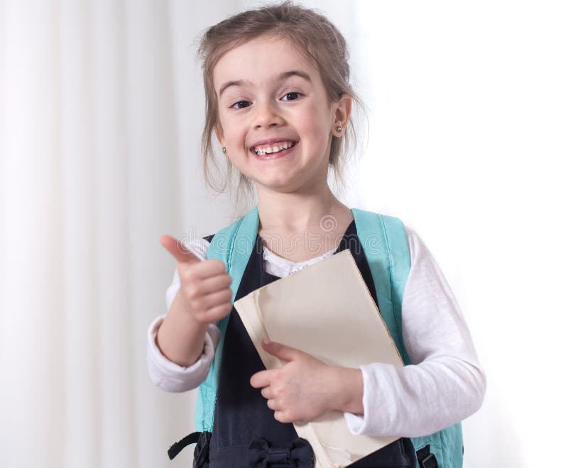 Girl-elementary School Student with a Backpack and a Book Stock Photo ...