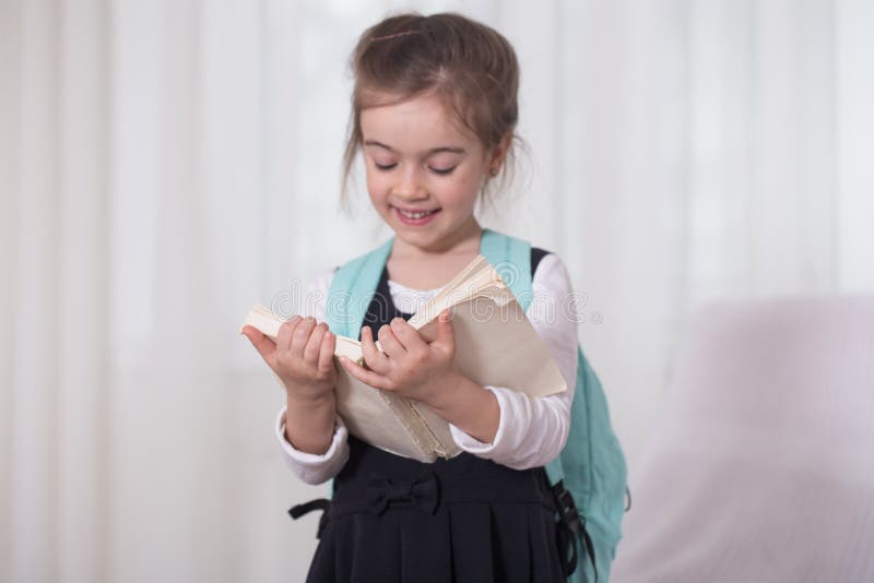 Girl-elementary School Student with a Backpack and a Book Stock Image ...