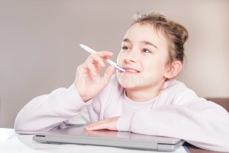 The Girl is Engaged in Distance Learning. Home Study. the Girl at the ...