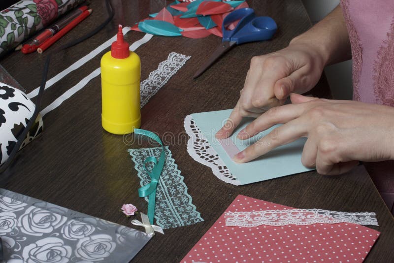 The Girl is Engaged in Making Greeting Cards at Home. Using Paper, Lace ...