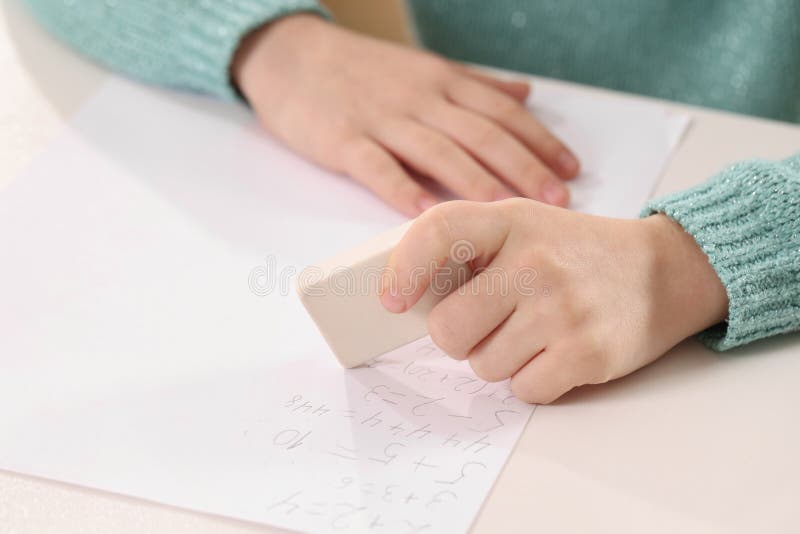 Girl Erasing Mistake in Her Homework at White Desk, Closeup Stock Photo ...