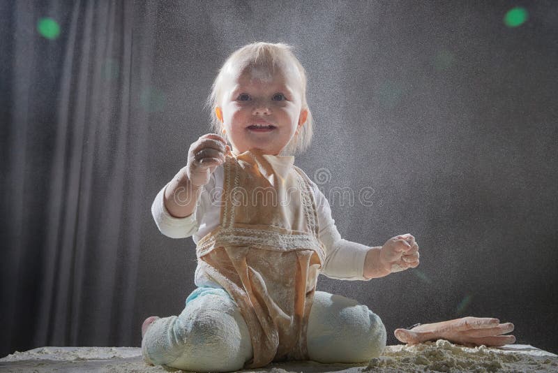 A Young Girl Joyfully Plays with Flour during a Creative Cooking-themed ...