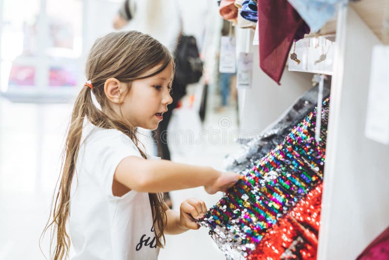 Girl in a Fabric Store Chooses a Multi-colored Fabric Stock Photo ...