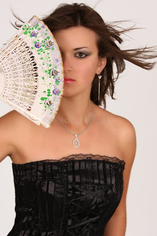 Girl with Fan Over Her Face Stock Photo - Image of person, black: 9928290