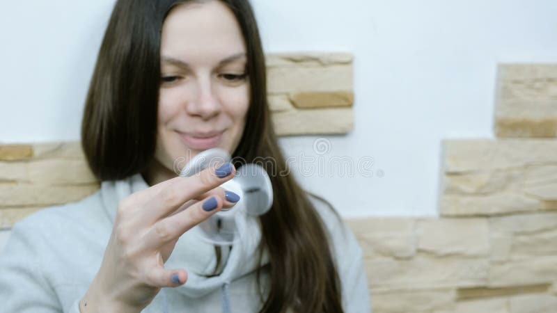 Girl Fiddling with Fidget Spinner while Sitting on the Floor Stock ...