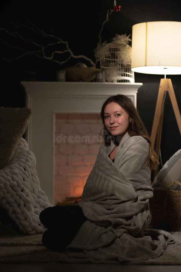 A Girl by the Fireplace Wrapped in a Blanket. Evening Rest Stock Image ...
