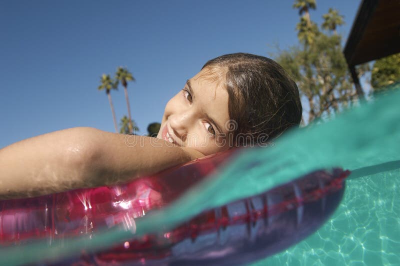 Girl Floating on Inflatable Ring in Pool Stock Photo - Image of looking ...