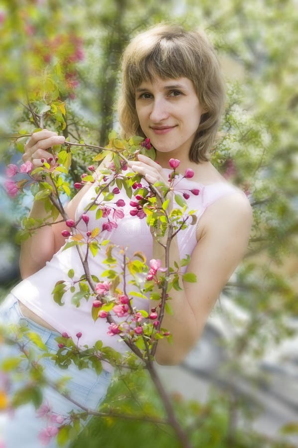 Girl with a flowering tree stock image. Image of portrait - 14626561