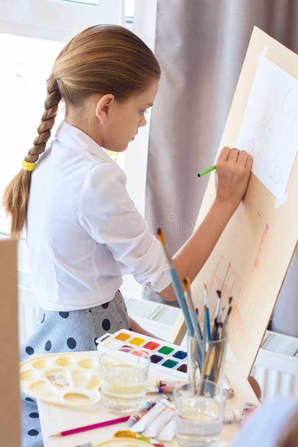 Girl is Focused on Drawing with a Pencil on an Easel Stock Photo ...