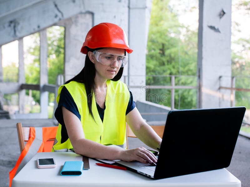 Girl Foreman with Laptop at Construction Site. Female Engineer Works on ...