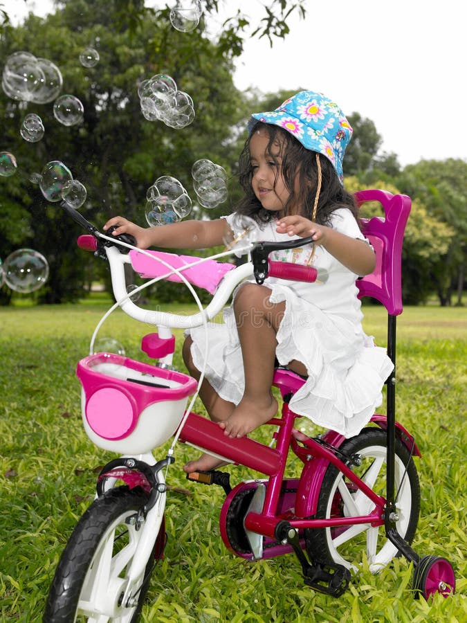 Girl in the Garden Riding Her Cycle Stock Image - Image of flying ...