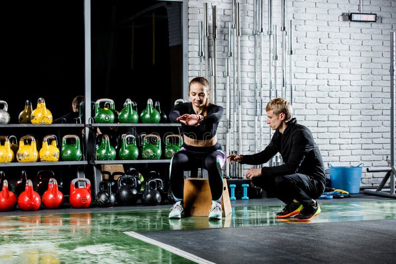 The Girl is Getting Ready for the Exercise with the Trainer Stock Image ...
