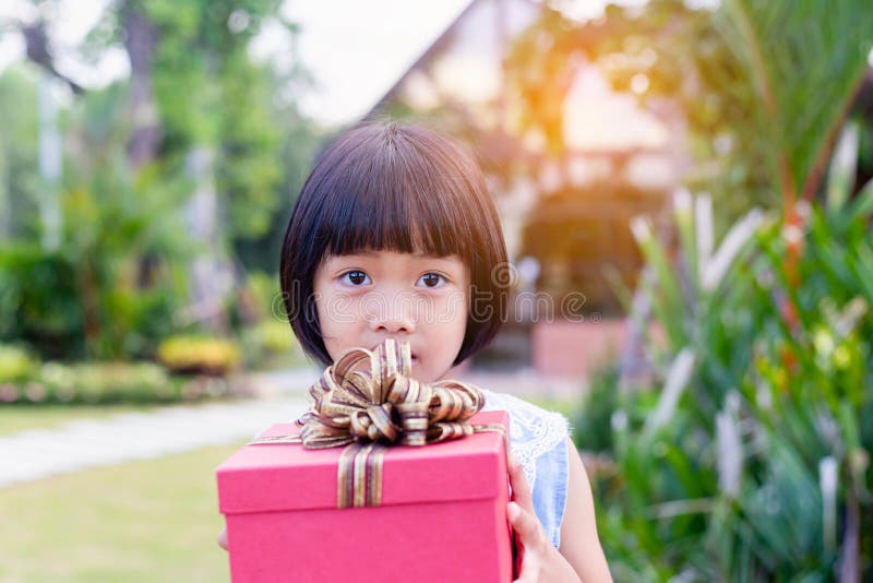 Girl Giving a Gift To Someone Special Stock Photo - Image of child ...