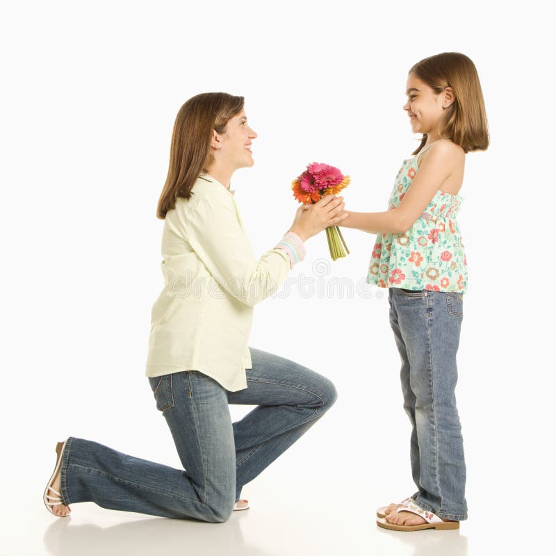 Girl giving mom flowers. stock photo. Image of bouquet - 2432124