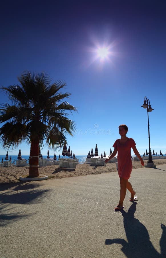 Girl Goes on Path with Palms on Empty Sandy Beach Stock Image - Image ...