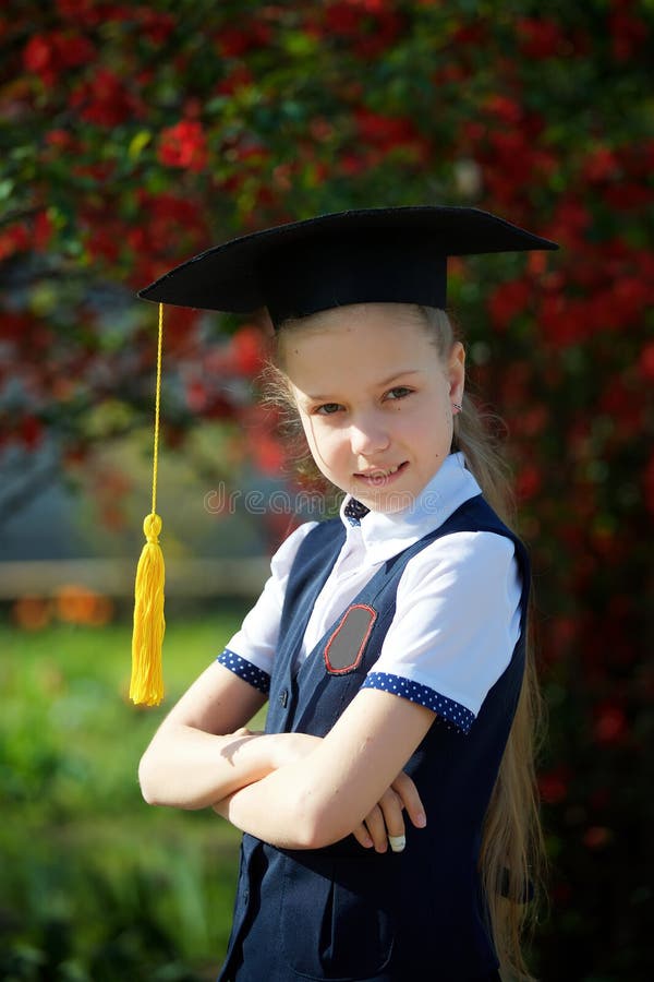 A Girl is a Graduate of an Elementary School in a Graduate Hat Stock ...