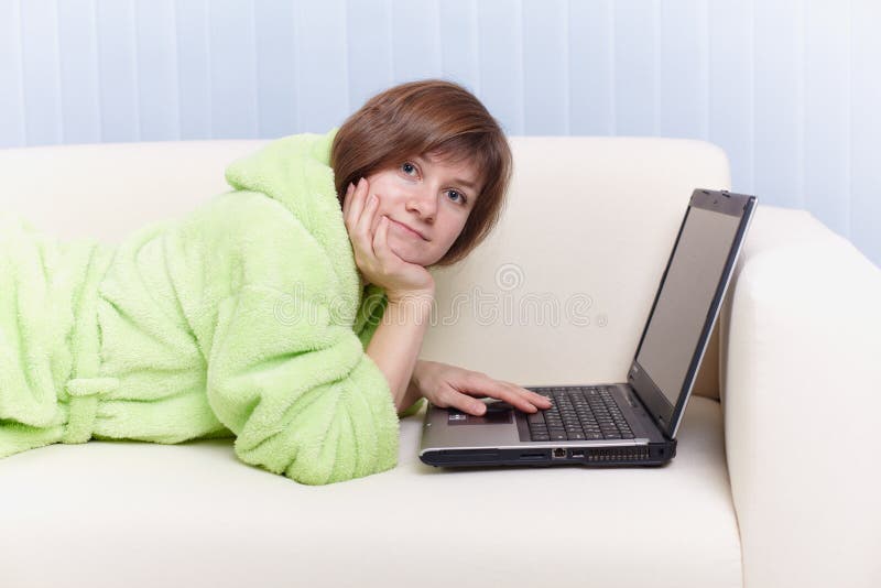 Girl in Green Dressing Gown on Sofa with Computer Stock Photo - Image ...