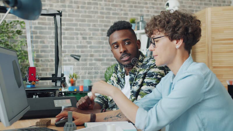 Girl and Guy Designing Details for Robot Using Computer and 3d Printer ...