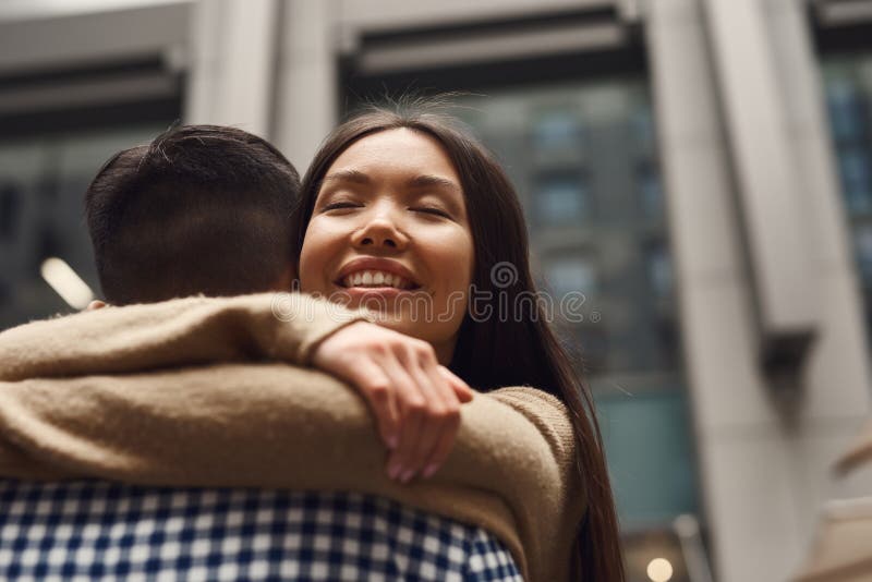 Girl with Guy Romantically Hugging on Building Background. Stock Photo ...